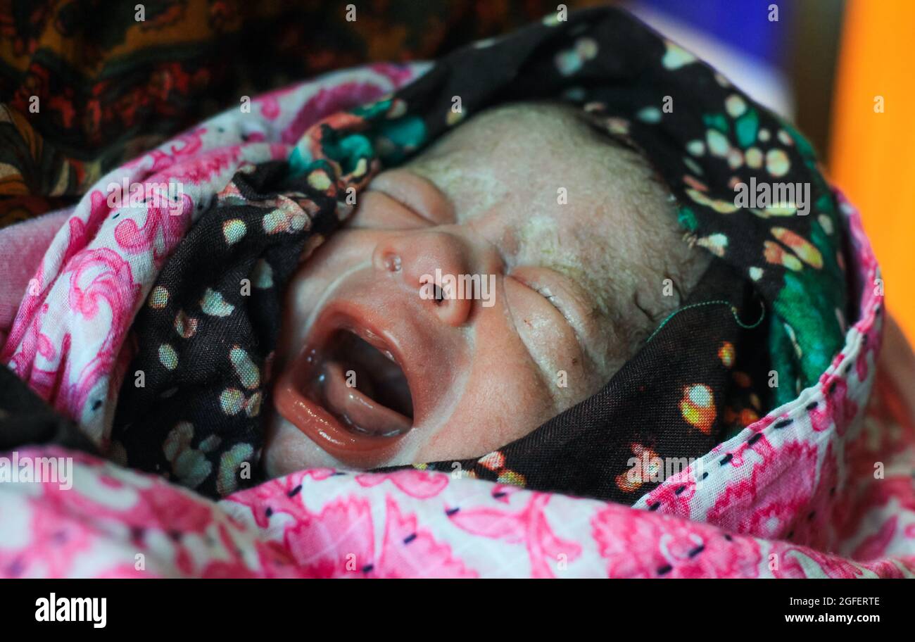Beautiful baby boy a few seconds after the birth. Baby crying after ...