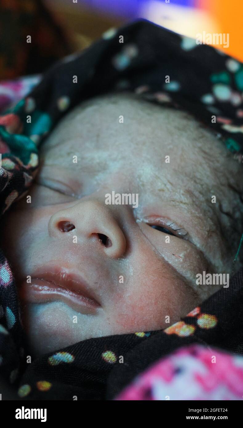 Beautiful baby boy a few seconds after the birth. Baby crying after ...