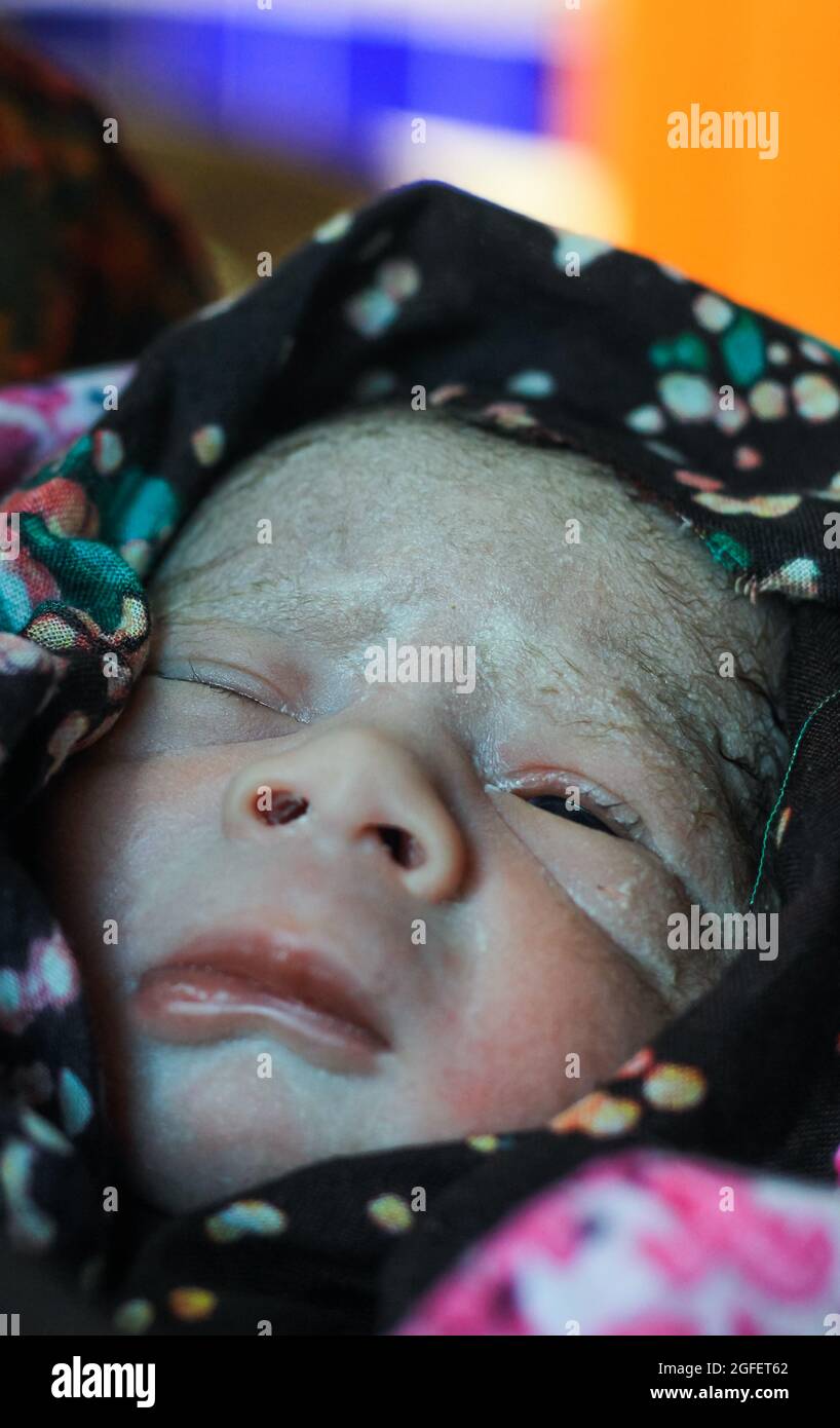 Beautiful baby boy a few seconds after the birth. Baby crying after ...