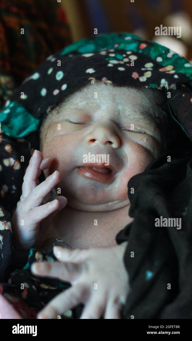 Beautiful baby boy a few seconds after the birth. Baby crying after ...
