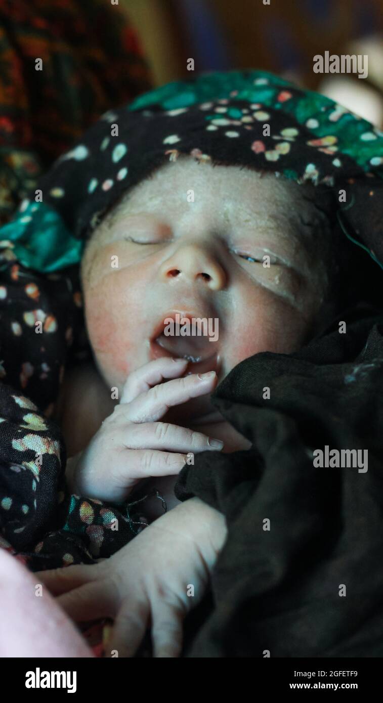 Beautiful baby boy a few seconds after the birth. Baby crying after ...