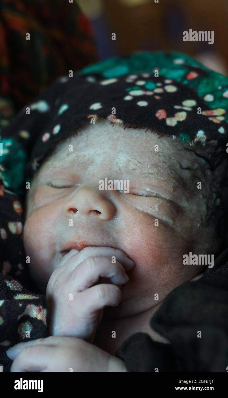 Beautiful baby boy a few seconds after the birth. Baby after birth ...