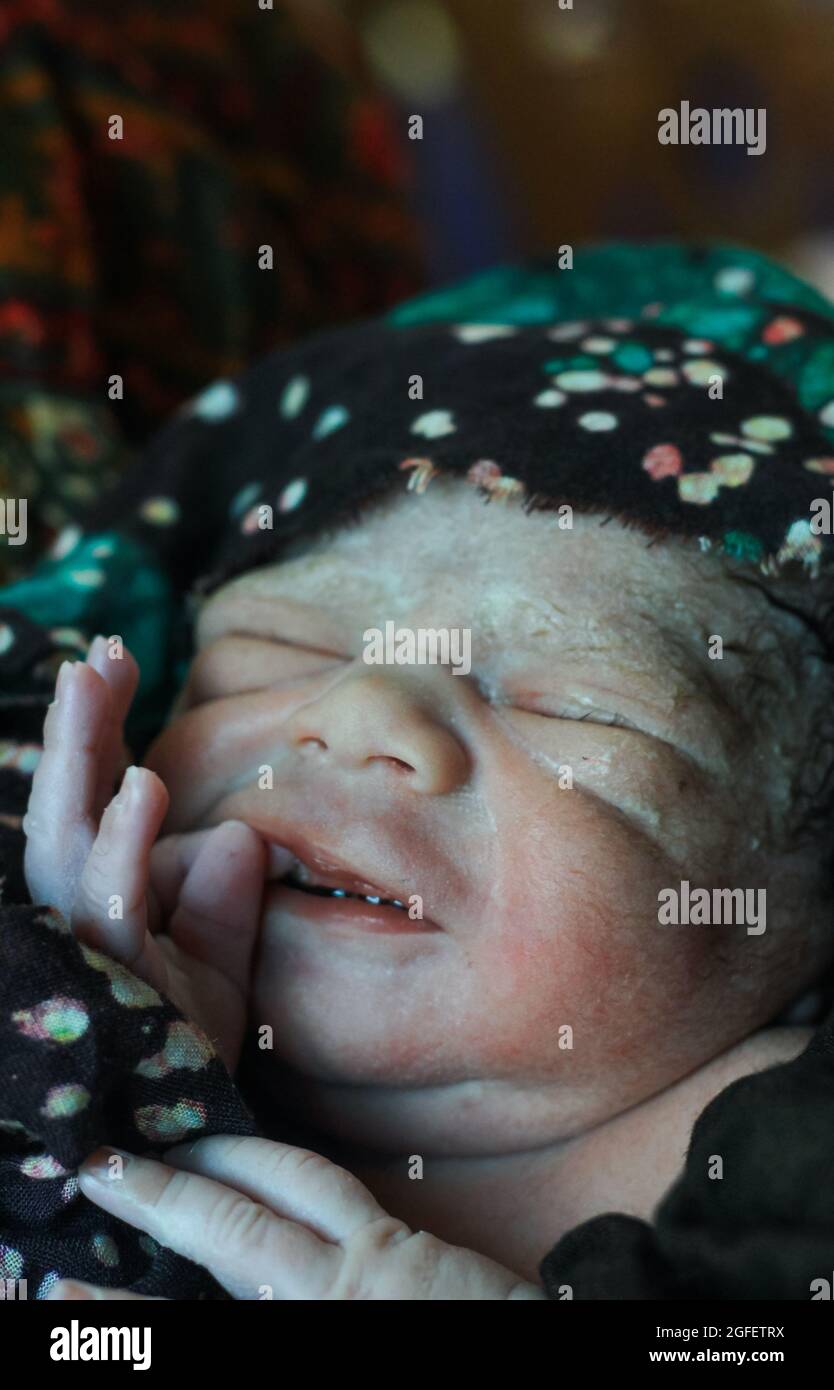 Beautiful baby boy a few seconds after the birth. Baby crying after ...