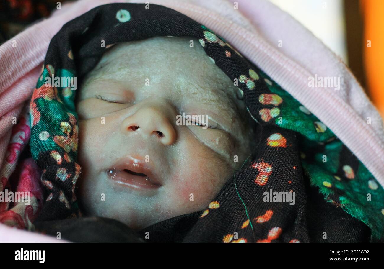 Beautiful baby boy a few seconds after the birth. Baby after birth ...