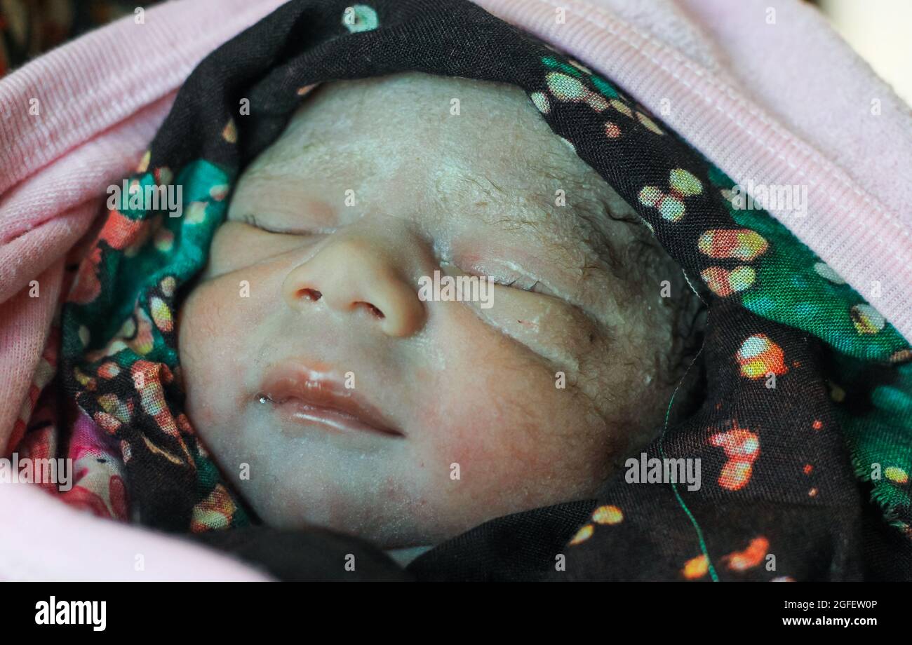 Beautiful baby boy a few seconds after the birth. Baby after birth ...