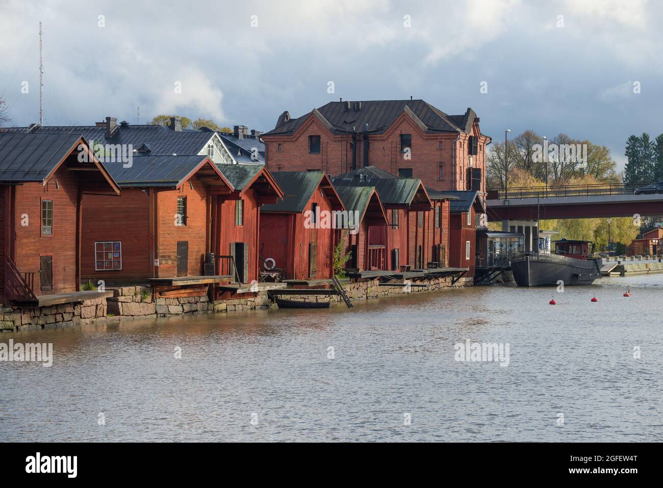 Old wooden barns on the embankment of the Porvoonjoki river on a cloudy ...
