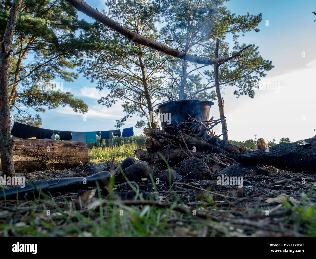 Cooking a meal on a campfire in metal vessels during a canoeing ...