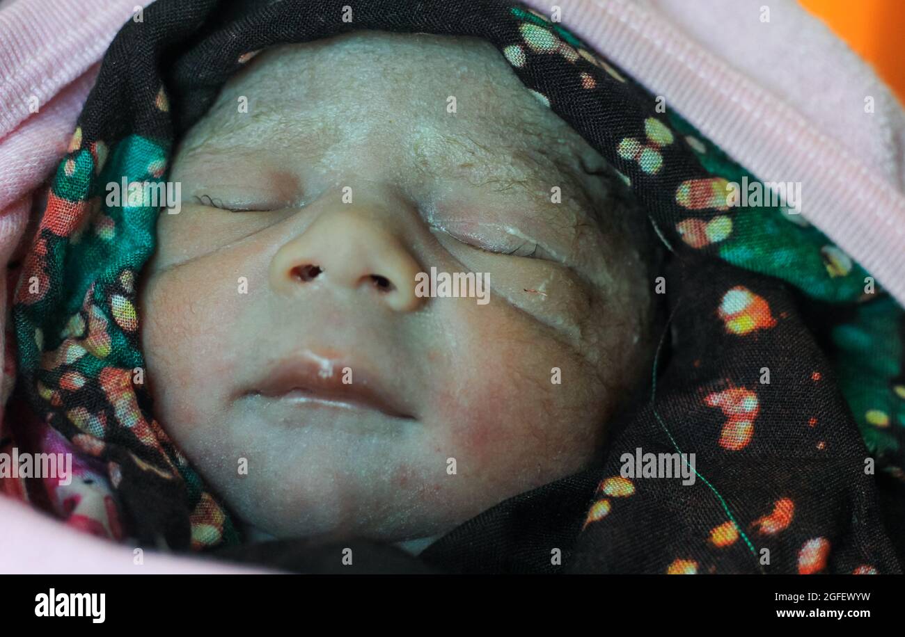 Beautiful baby boy a few seconds after the birth. Baby after birth ...