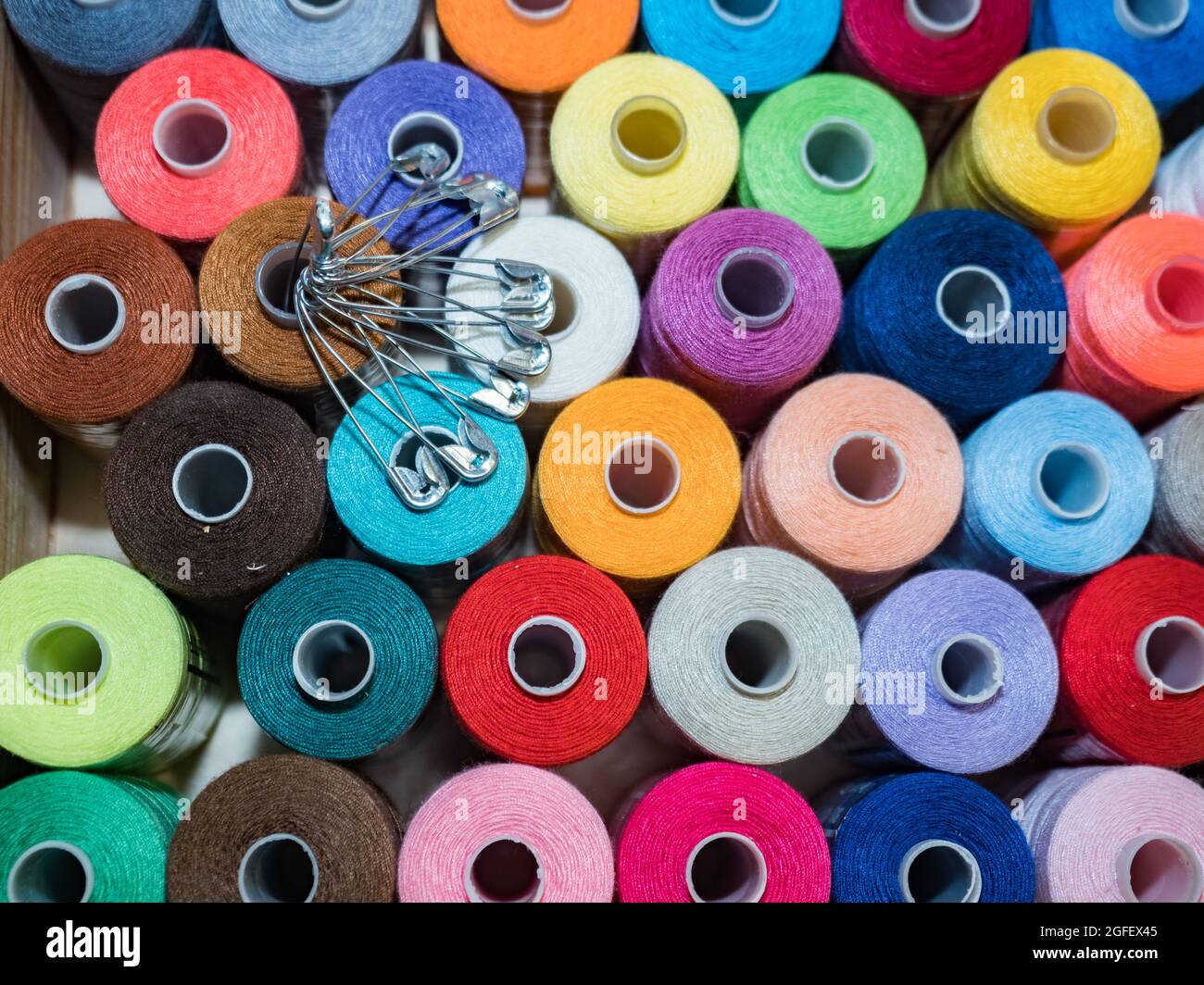 A lot of sewing colored thread. Thread reels. Colorful threads in the ...