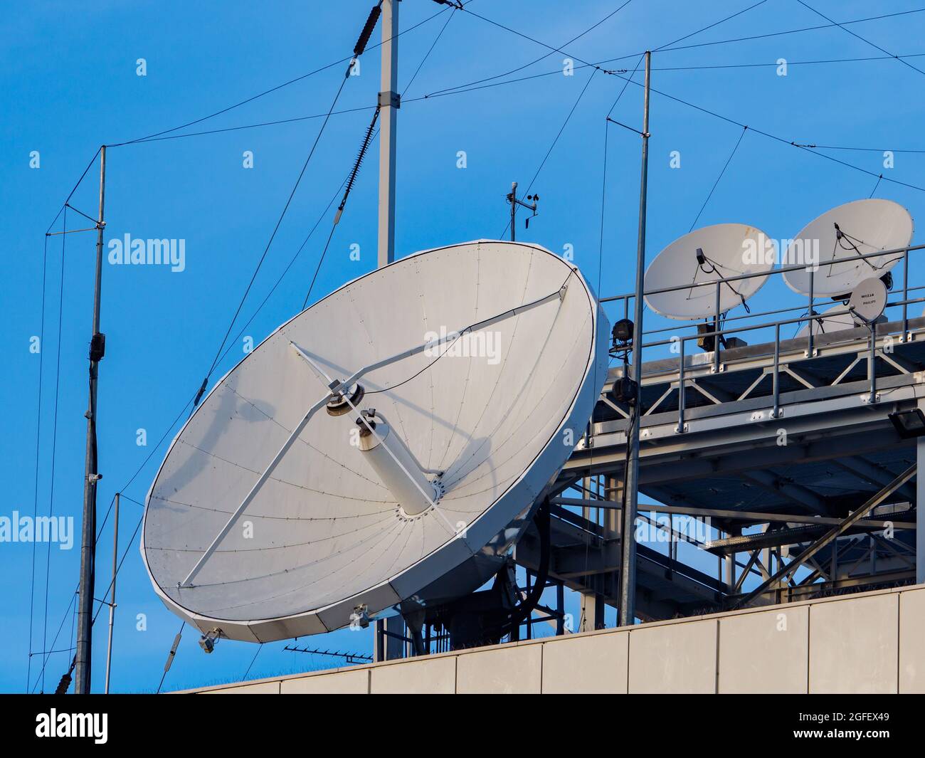 Satellite dishes against the background of blue sky Stock Photo - Alamy