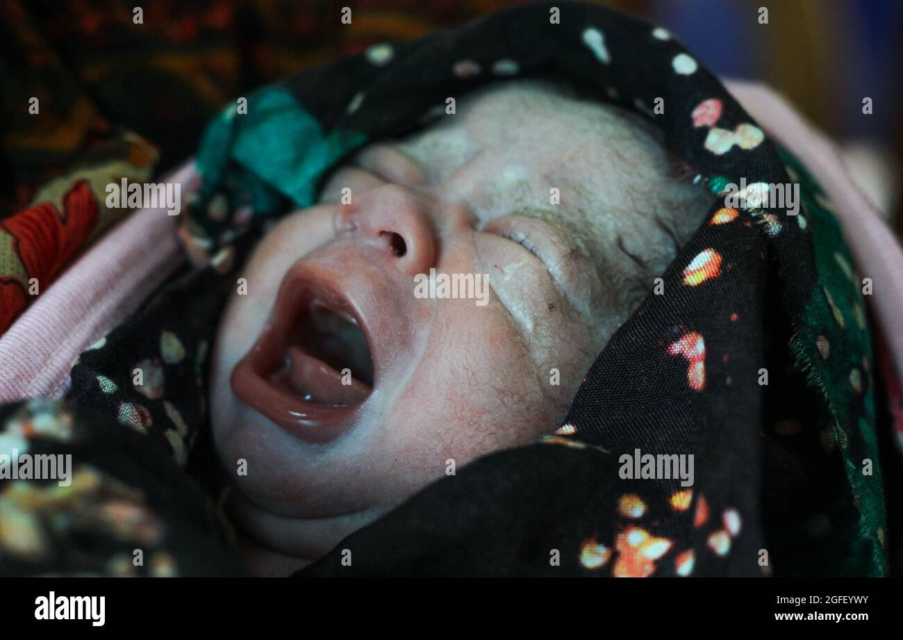 Beautiful baby boy a few seconds after the birth. Baby crying after ...