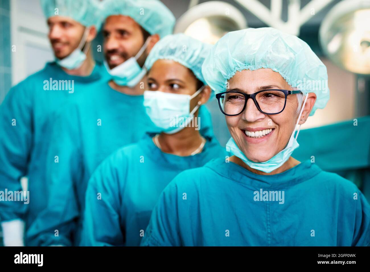 Successful team of surgeon standing in operating room, ready to work on ...