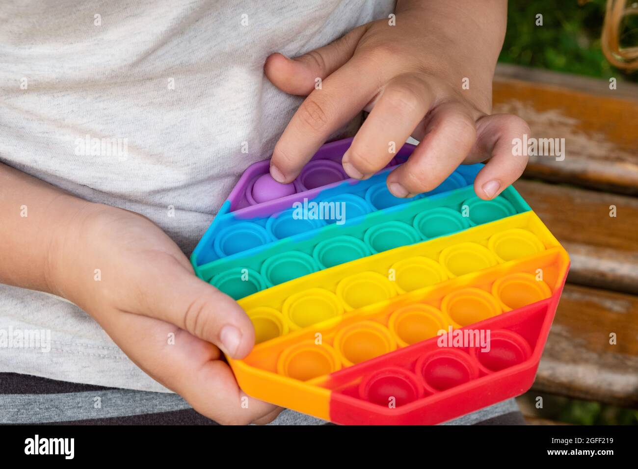 child play with finger press colorful pop It fidget toy Stock Photo - Alamy