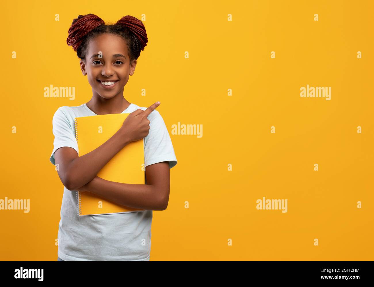 Happy african american school girl holding notepad Stock Photo - Alamy