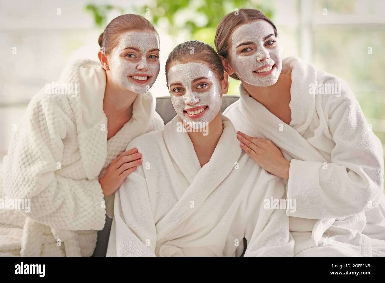 Beautiful girls with masks in spa salon Stock Photo - Alamy
