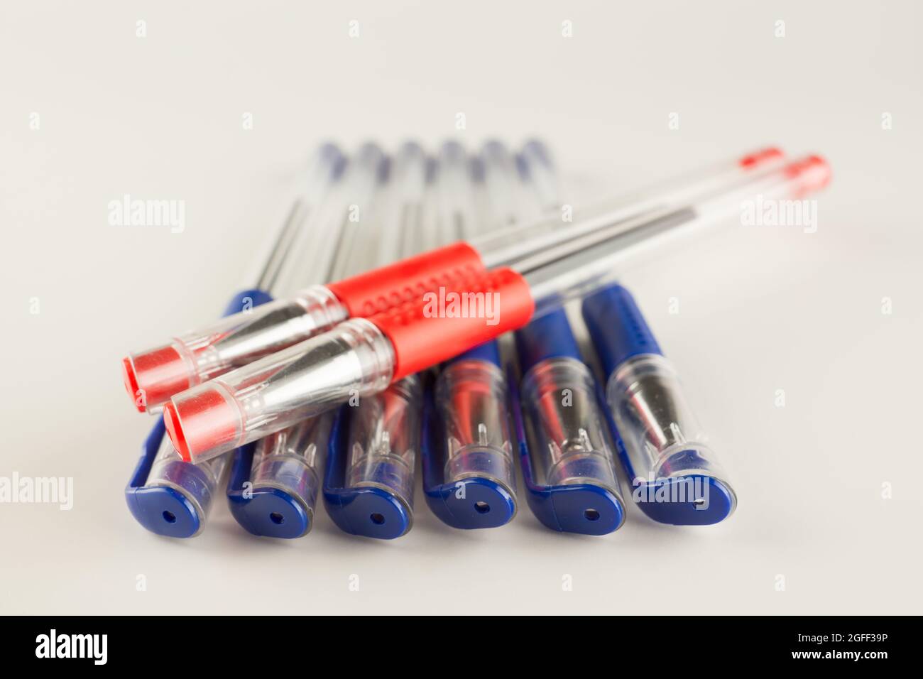 set of blue ballpoint pens lined up hardly on a white background Stock ...