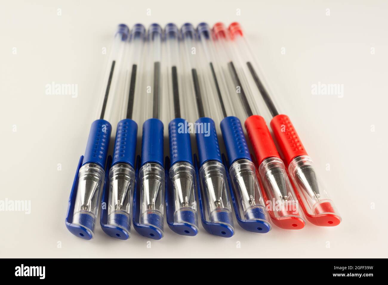 set of blue ballpoint pens lined up hardly on a white background Stock ...