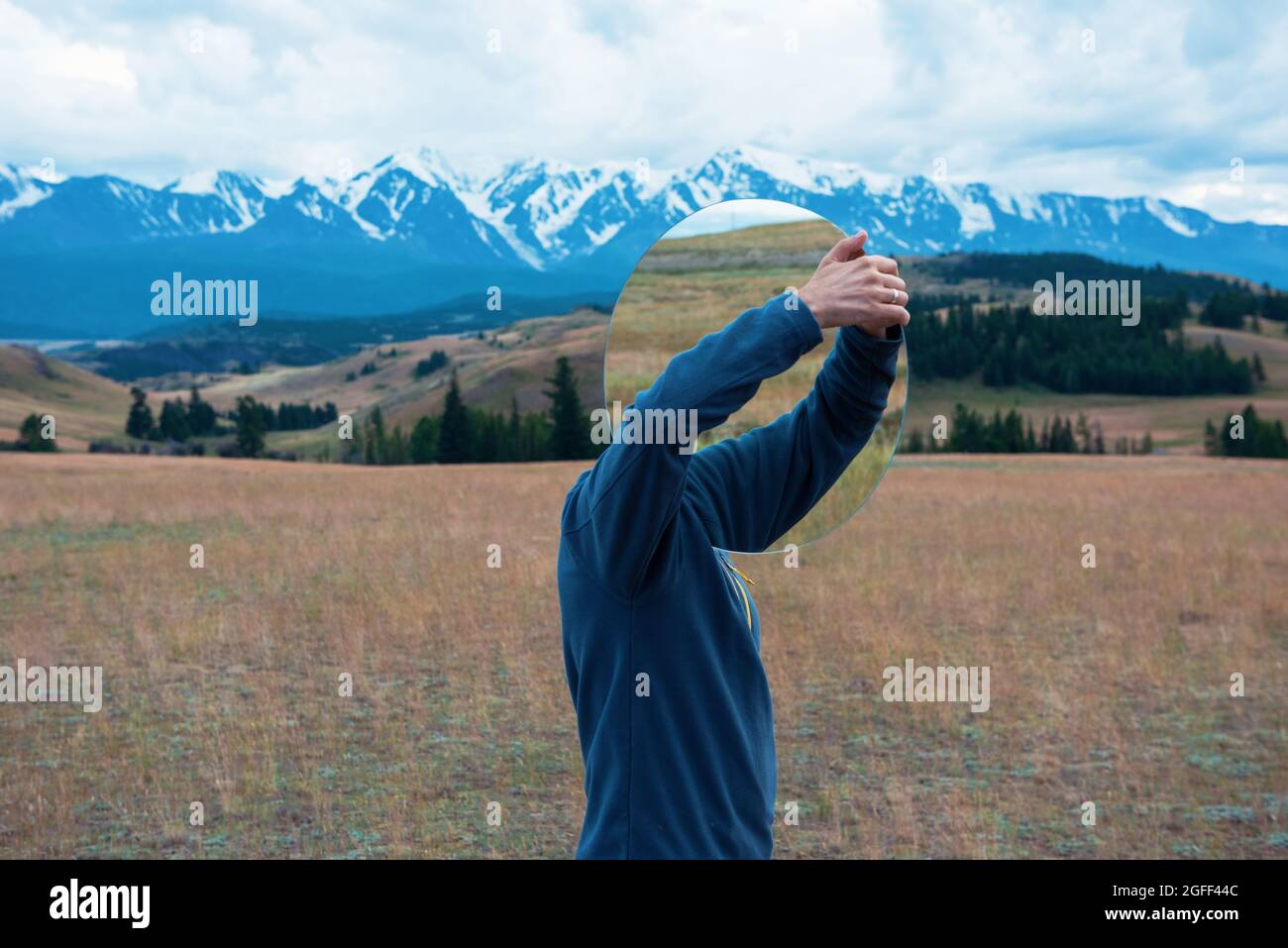 Man standing in in summer Altai mountains in Kurai steppe and holding ...