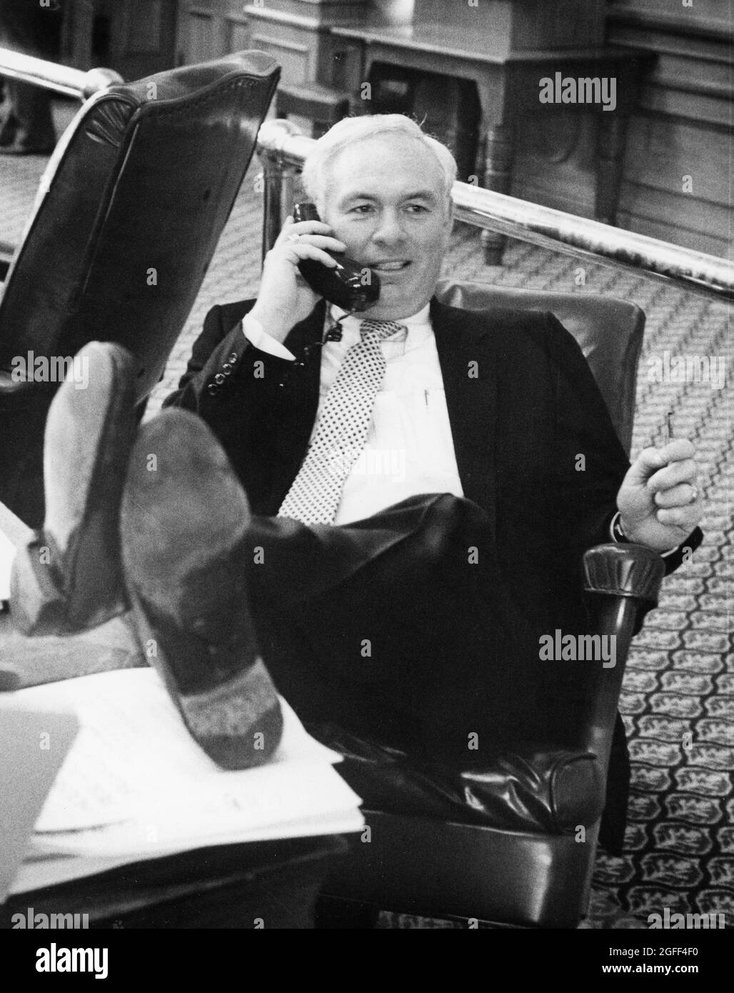 Austin Texas USA, 1989: Texas State Rep. JIM RUDD puts his feet up on ...