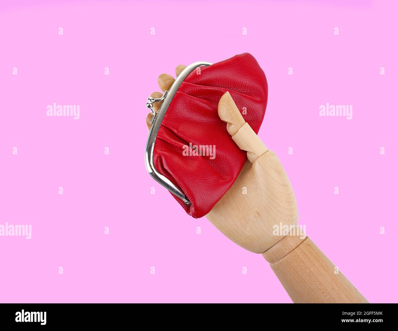 Wooden hand holding purse on white background Stock Photo - Alamy