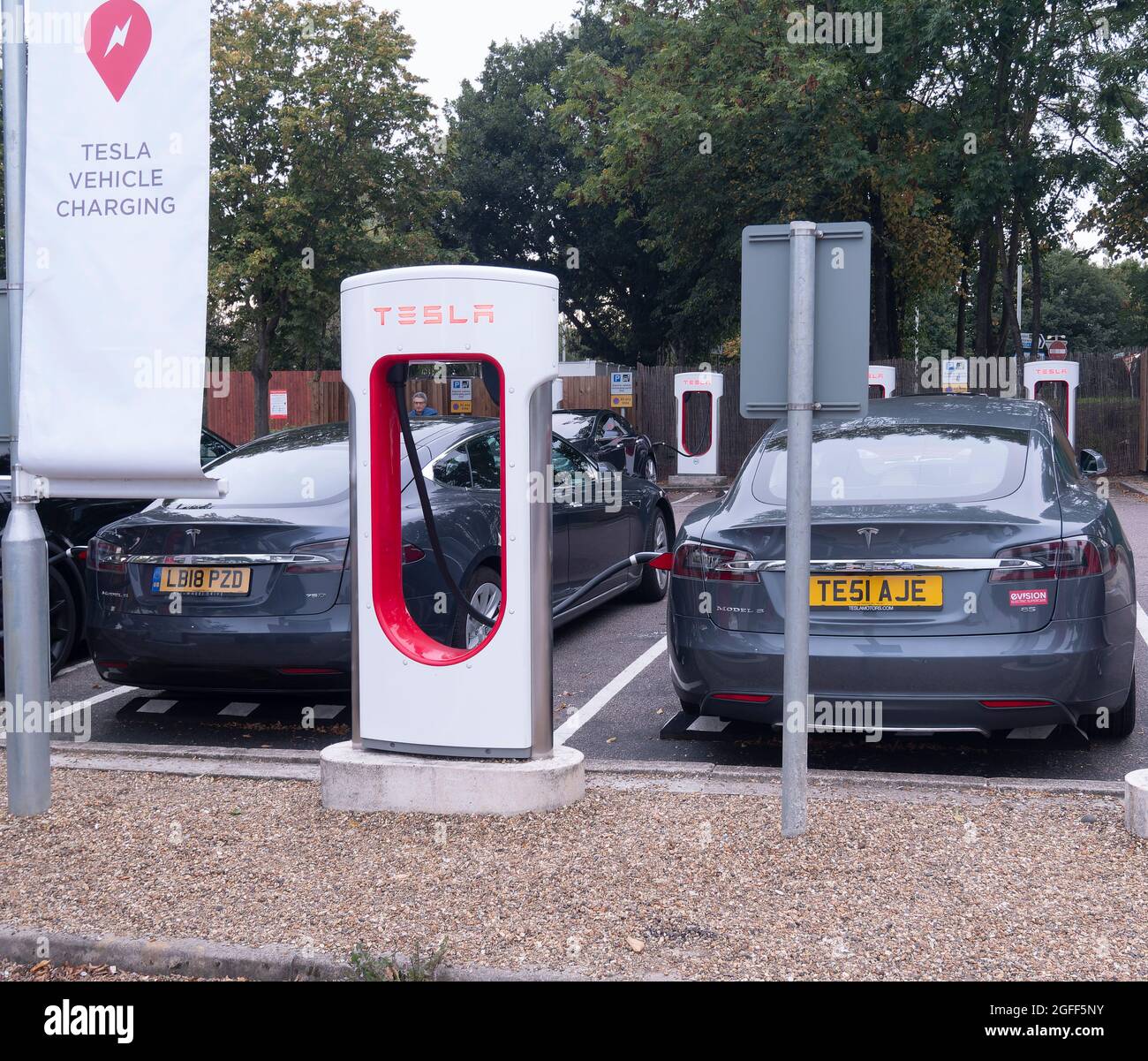 Electric vehicle charging Tesla cars and chargers Stock Photo - Alamy