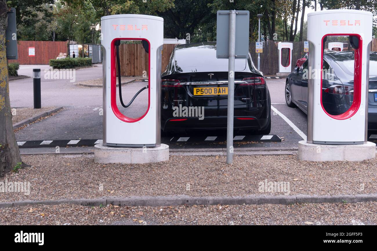 Electric vehicle charging Tesla cars and chargers Stock Photo - Alamy