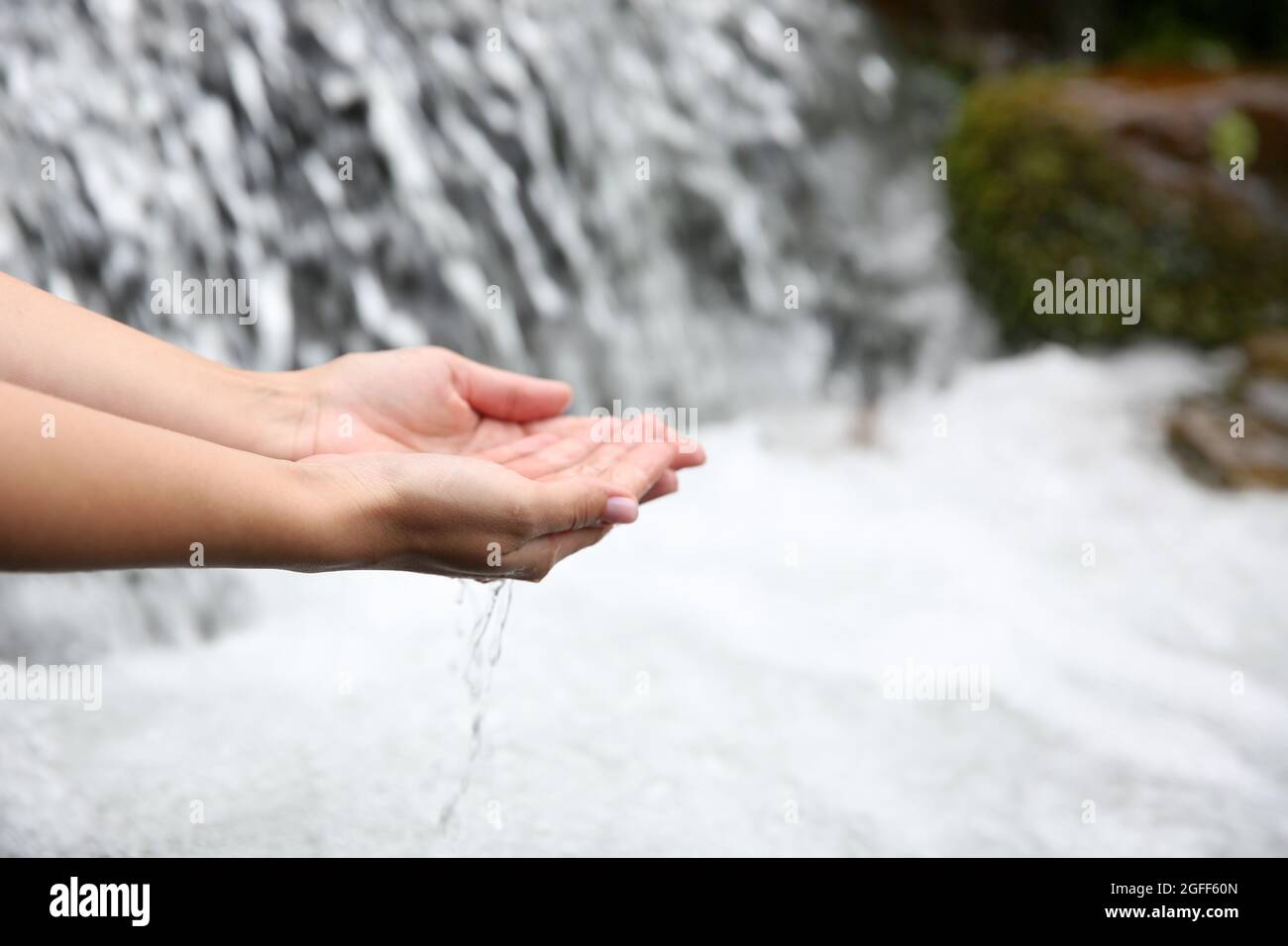 Female hands near water stream Stock Photo - Alamy