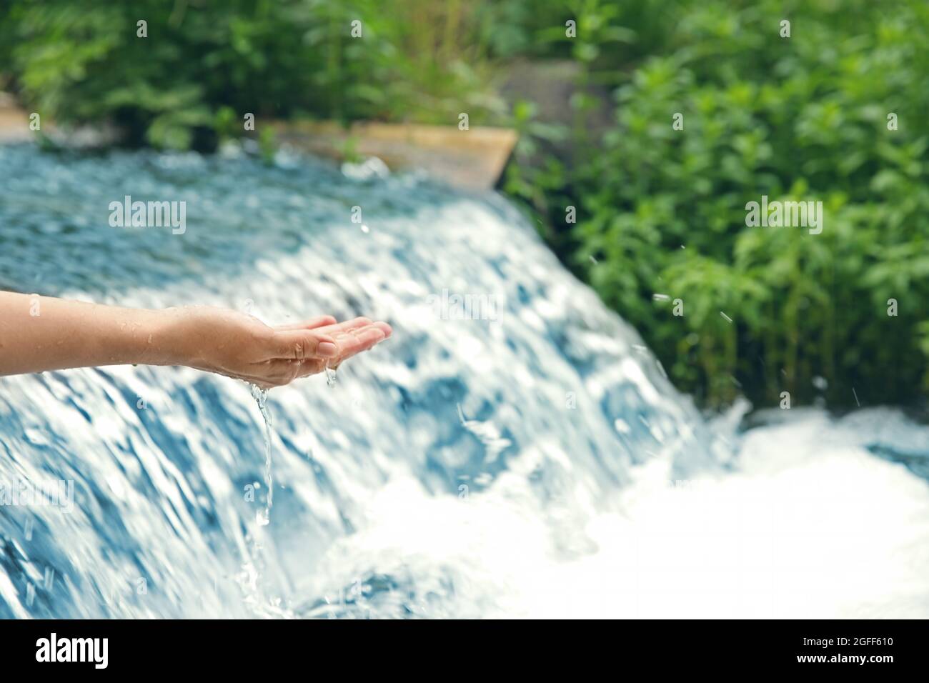 Female hand near water stream Stock Photo - Alamy