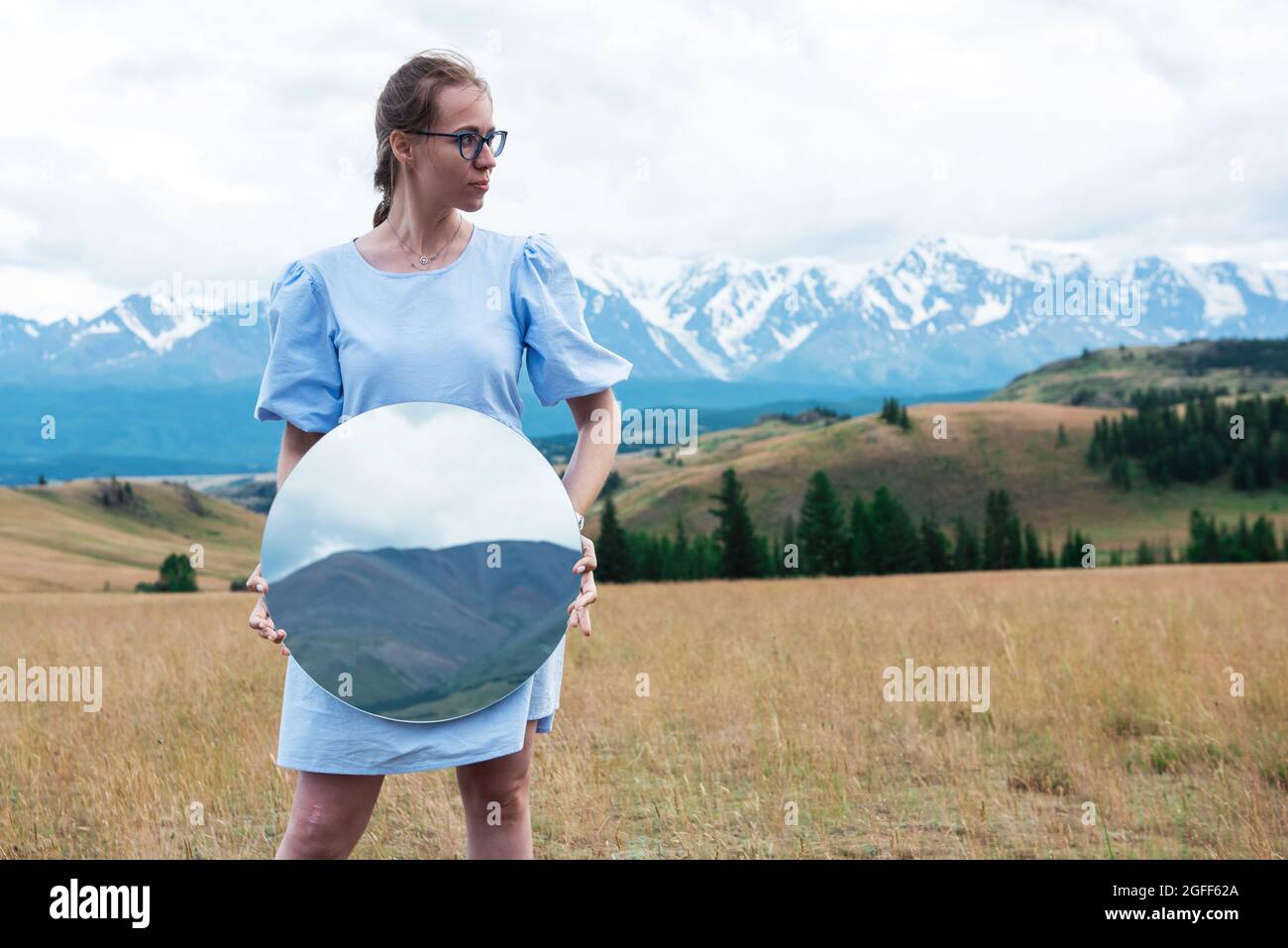 Man standing in in summer Altai mountains in Kurai steppe and holding ...