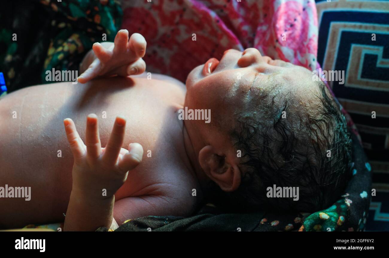 Beautiful baby boy a few seconds after the birth. Baby crying after ...