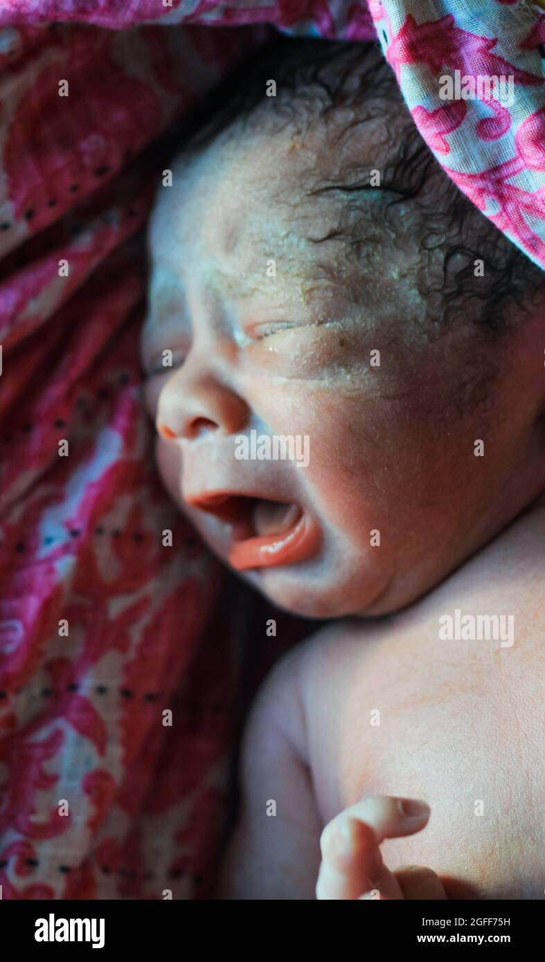 Beautiful baby boy a few seconds after the birth. Baby crying after ...