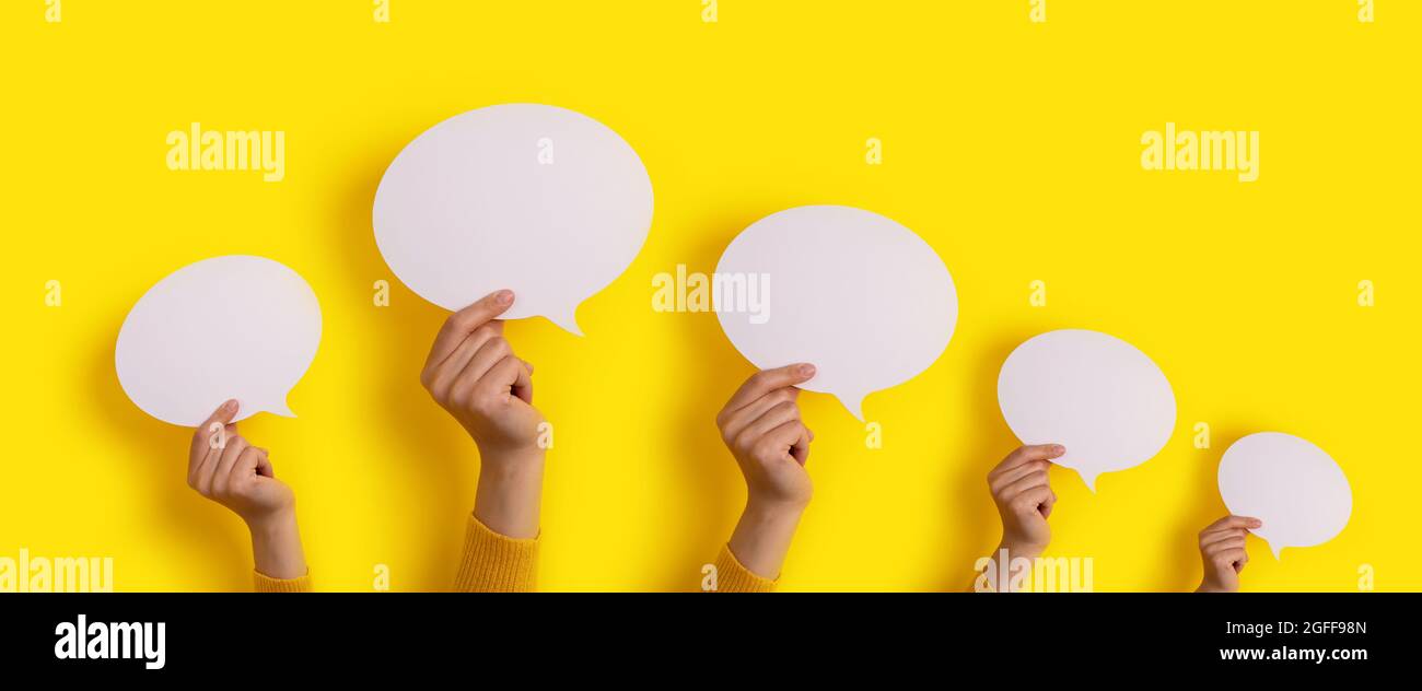 speech bubbles in hand over yellow background, panoramic layout over ...