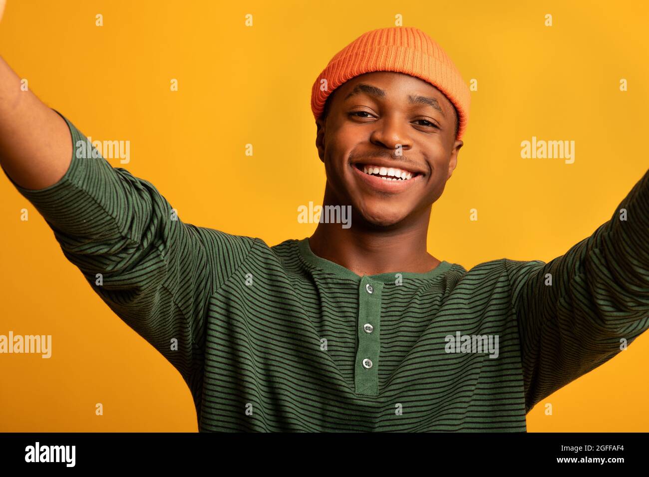 Self-Portrait. Cheerful African American Guy Taking Selfie Over Yellow ...