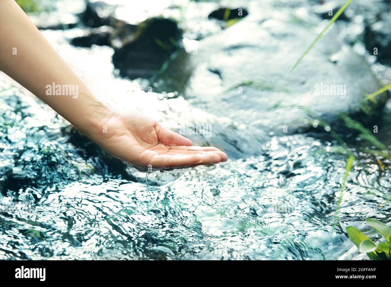 Woman pouring water in hand Stock Photo - Alamy