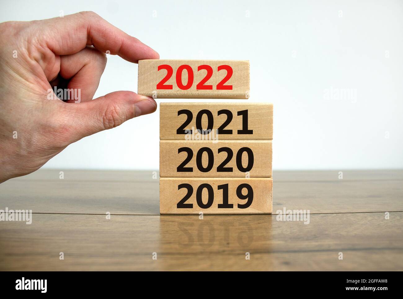 2022 happy new year symbol. Businessman holds a block with number '2022 ...