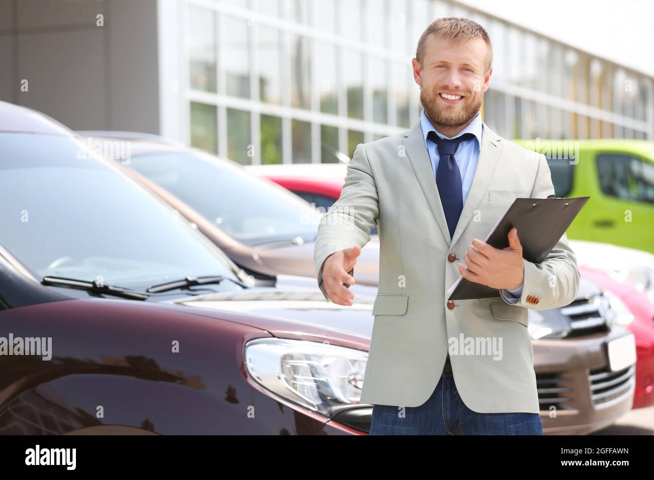 Car dealer on new cars background Stock Photo - Alamy