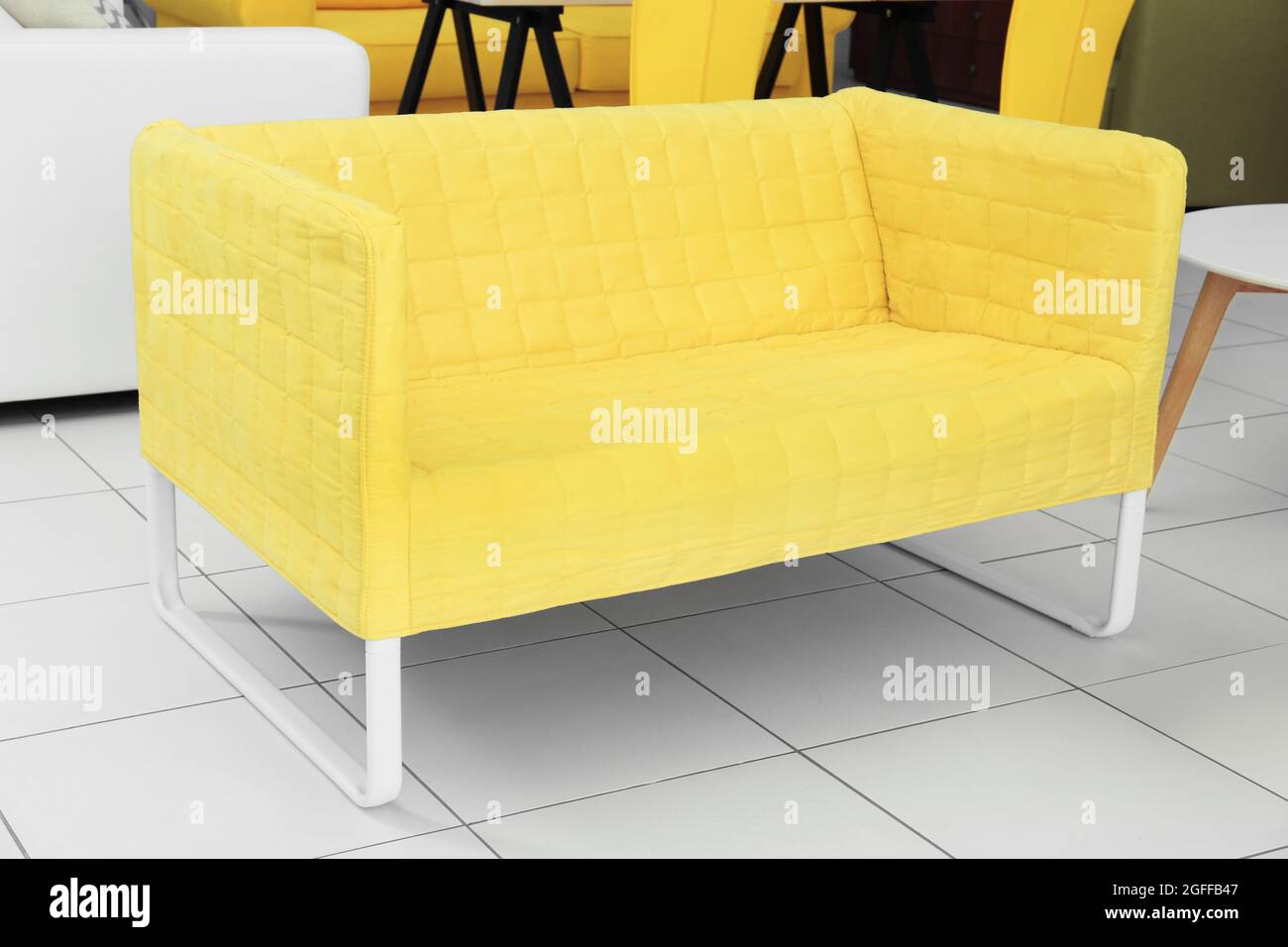 Stylish yellow couch in interior Stock Photo - Alamy