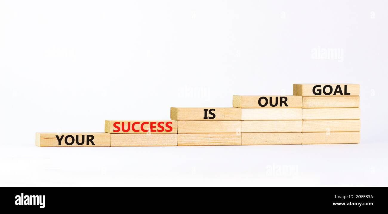 Your success business symbol. Wooden blocks with words 'your success is our goal'. Beautiful ...