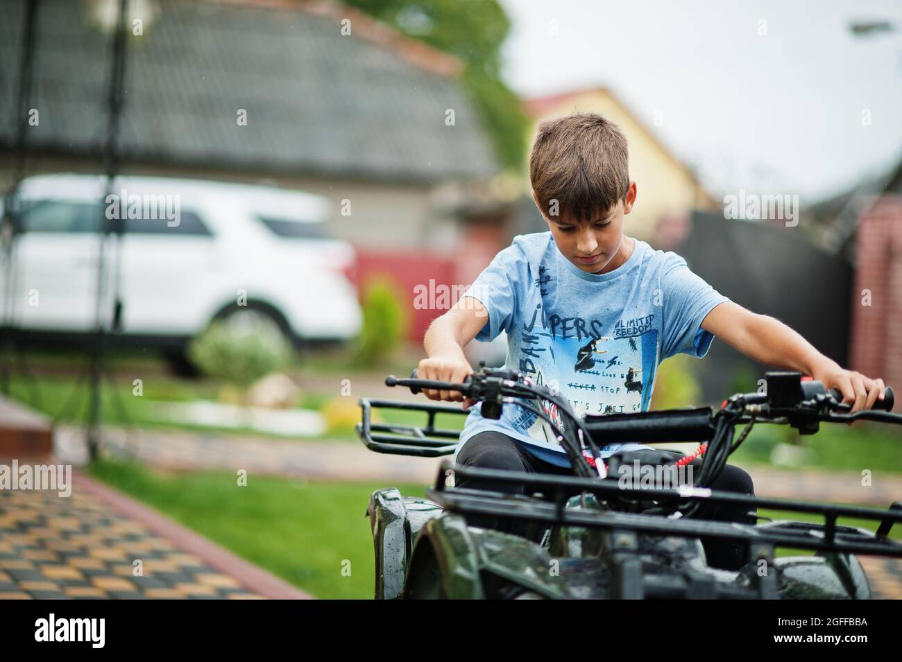 Boy in four-wheller ATV quad bike Stock Photo - Alamy