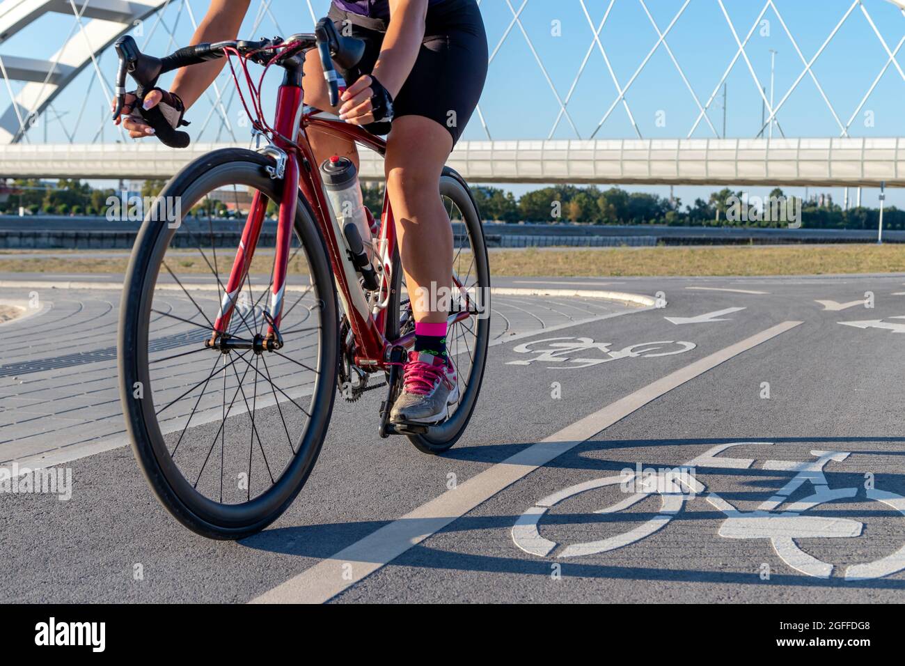Female cyclist riding a bicycle outdoors. Sports women cycling ...