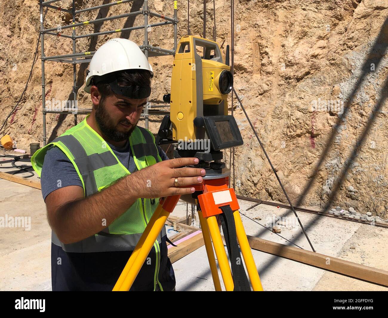 Land surveyor works at construction site Stock Photo - Alamy