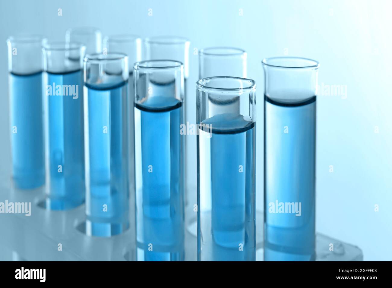 Test tubes with blue samples, close up Stock Photo - Alamy
