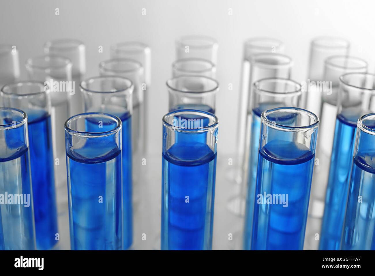Test tubes with blue samples, close up Stock Photo - Alamy
