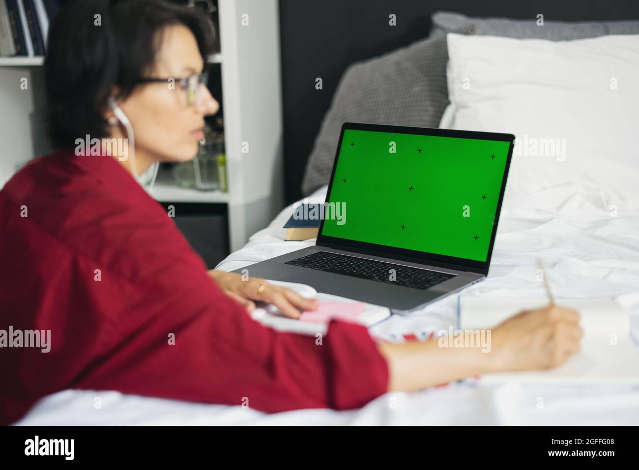 Studying on green screen laptop Stock Photo - Alamy