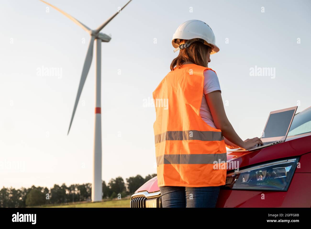 An windmill engineer supervises the work of the wind turbines on the ...