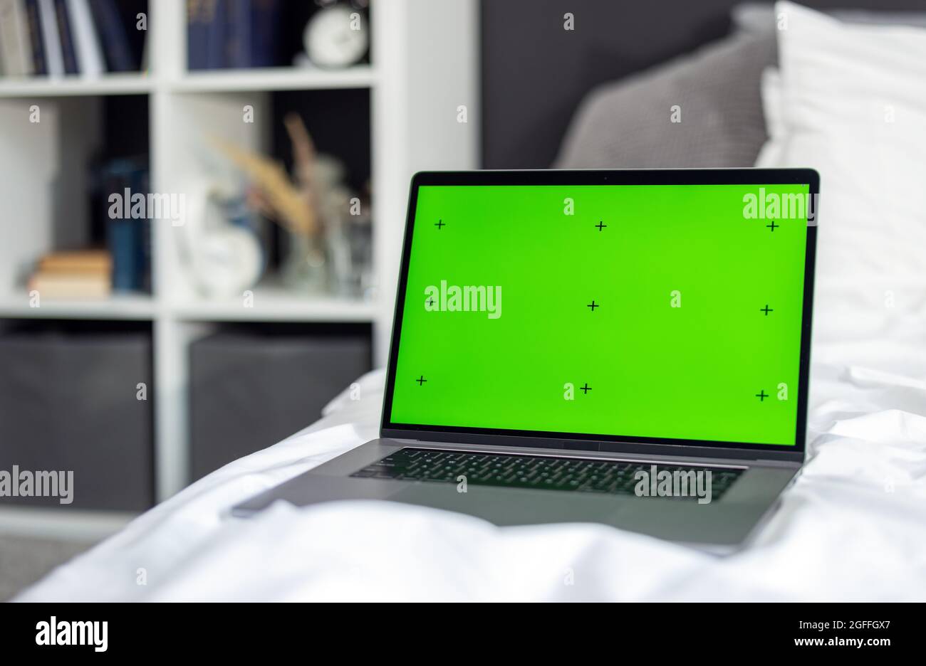 Green screen laptop on bed Stock Photo - Alamy