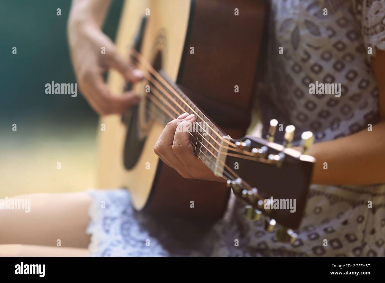 Beautiful woman playing guitar Stock Photo - Alamy