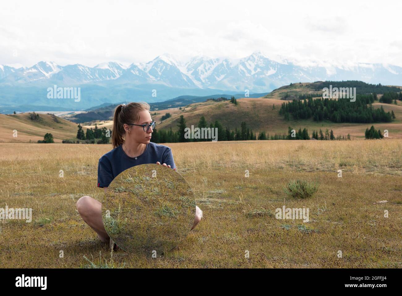 Man standing in in summer Altai mountains in Kurai steppe and holding ...