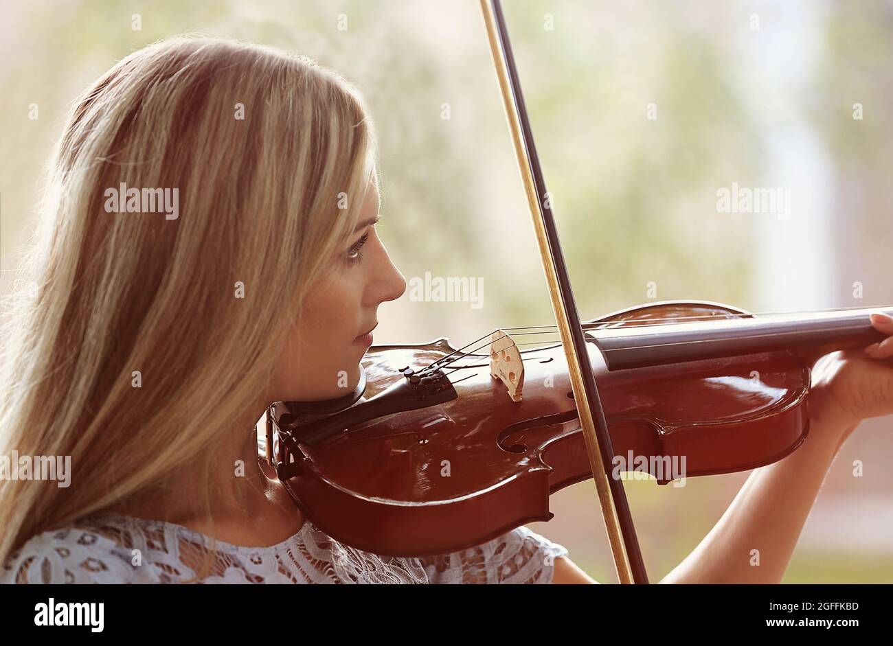 Beautiful woman playing violin Stock Photo - Alamy
