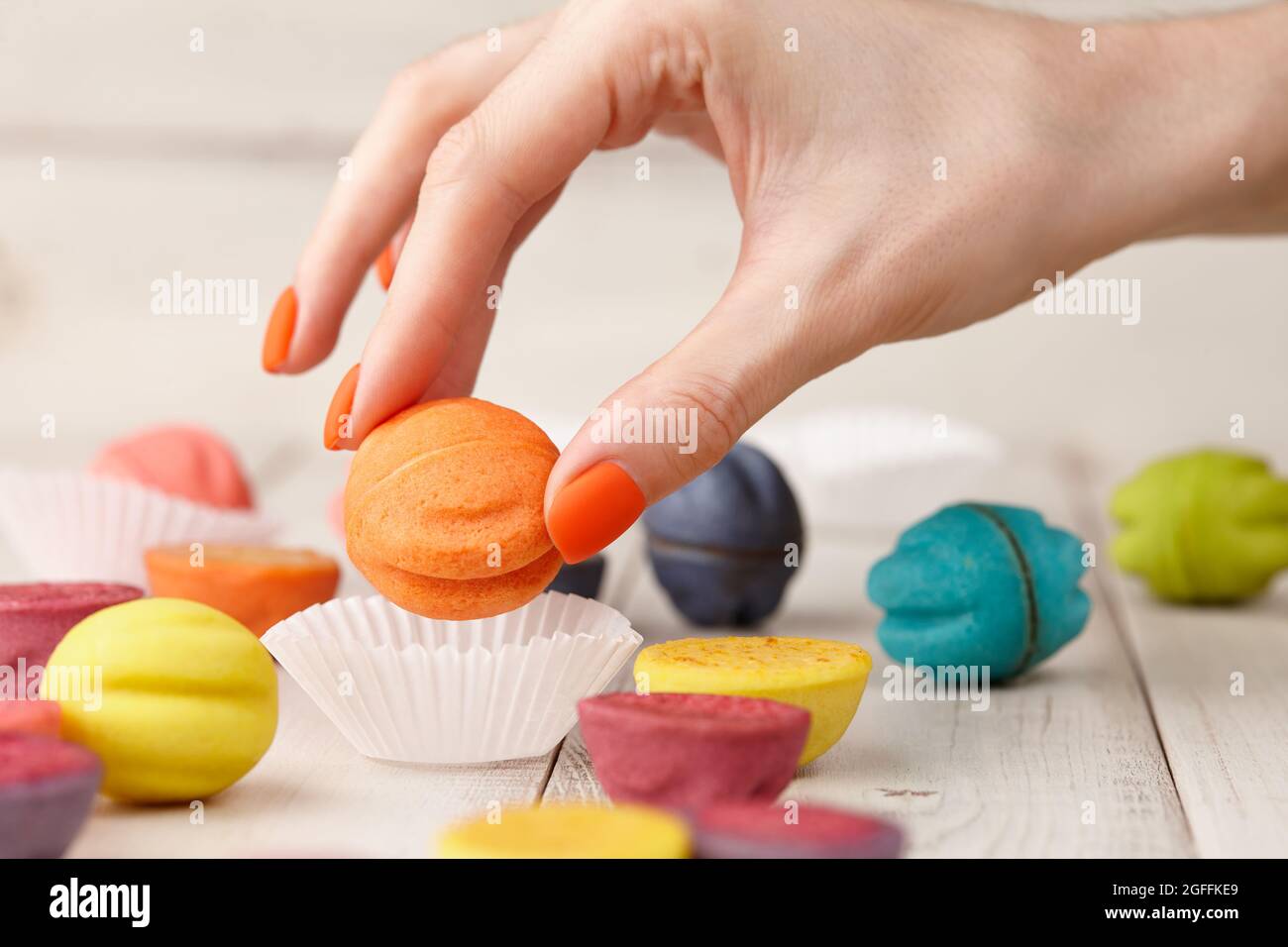 Hand taking sweet hi-res stock photography and images - Alamy
